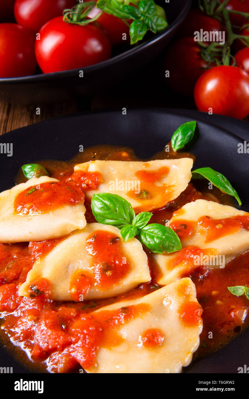 rustic Delicious Pasta - Ravioli in tomato sauce with basil Stock Photo ...