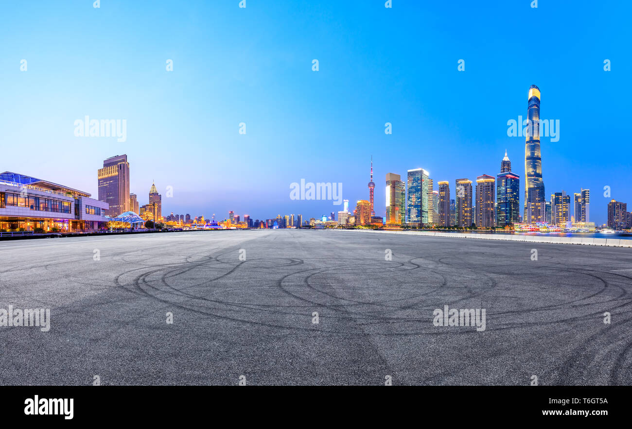 Asphalt race track ground and modern skyline and buildings in Shanghai ...