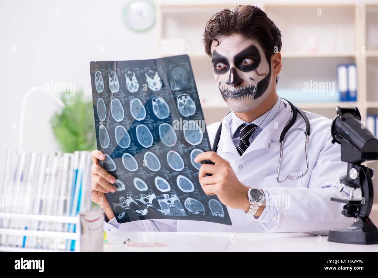 Scary monster doctor working in lab Stock Photo - Alamy