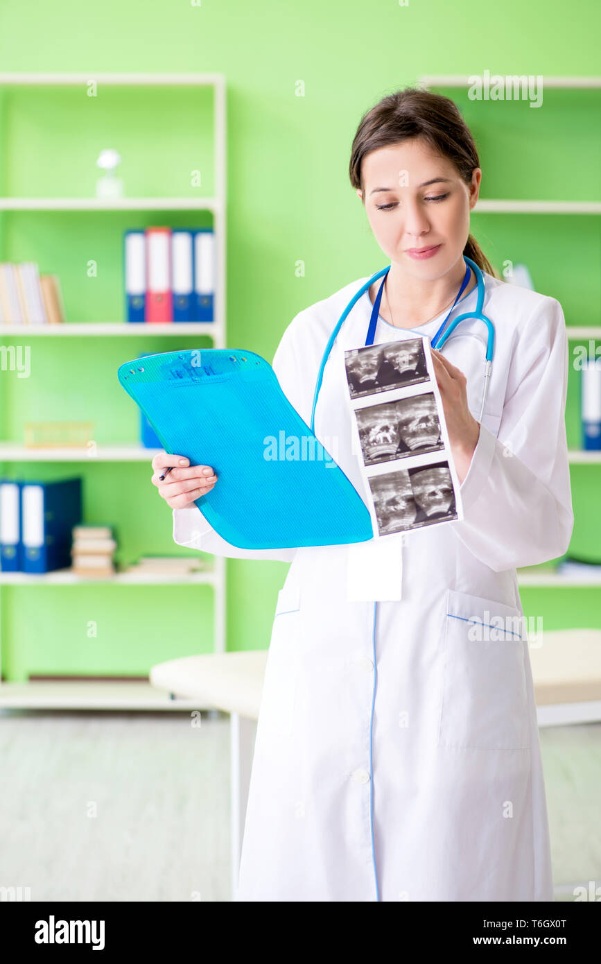 Female doctor gynecologyst writing medical record in the clinic Stock ...