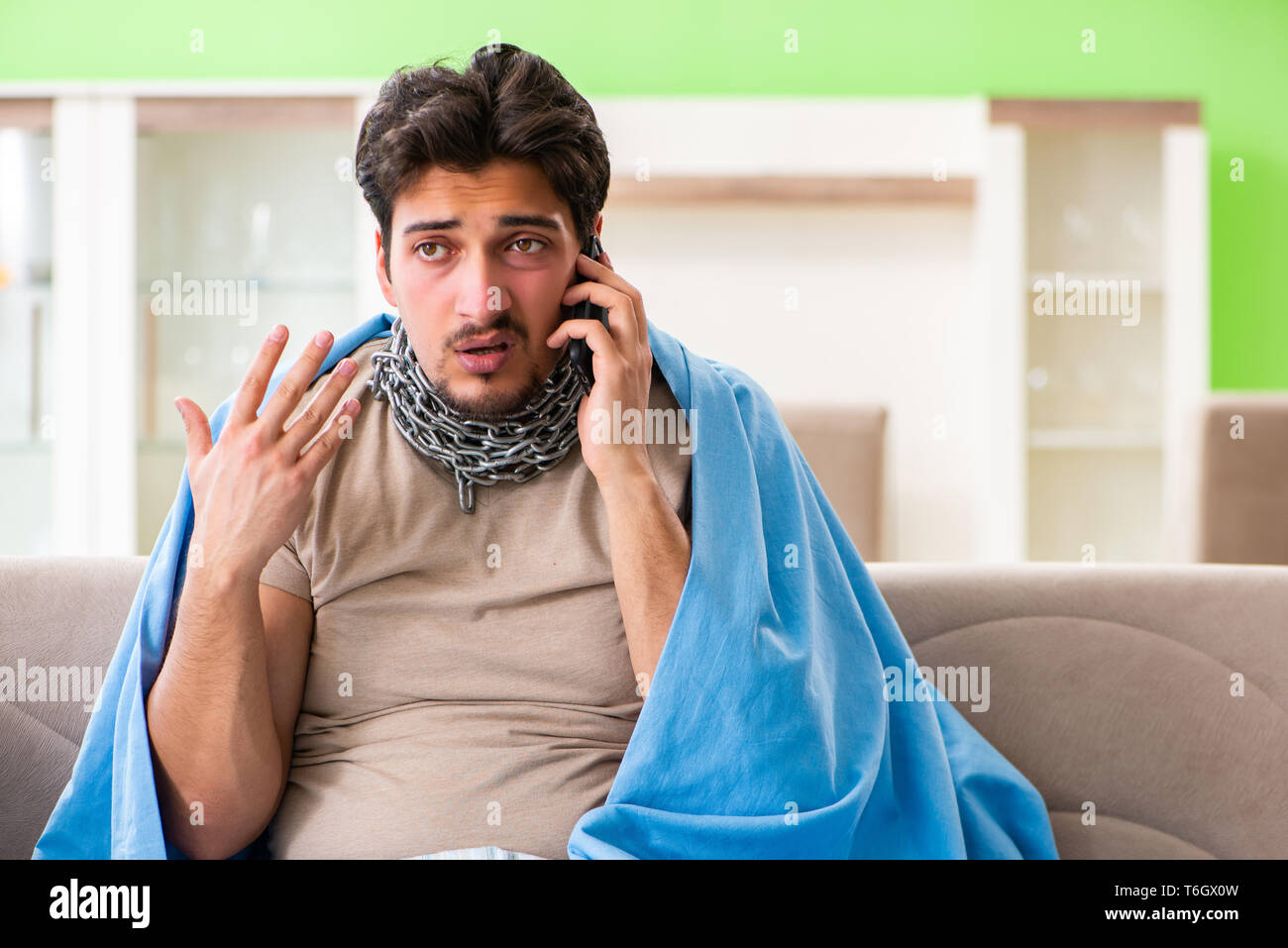 Sick young man suffering from flu at home Stock Photo - Alamy