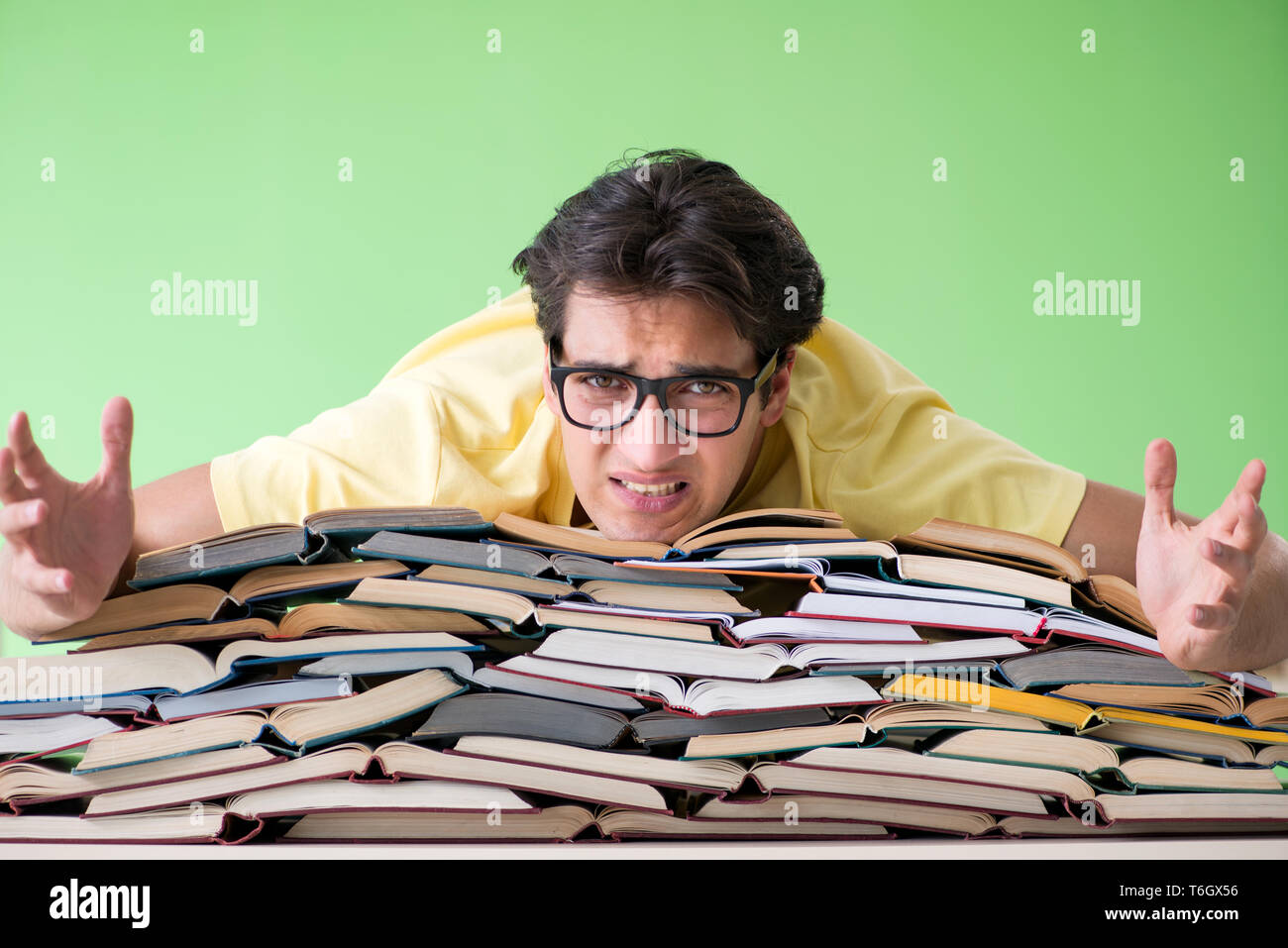 Student with too many books to read before exam Stock Photo - Alamy