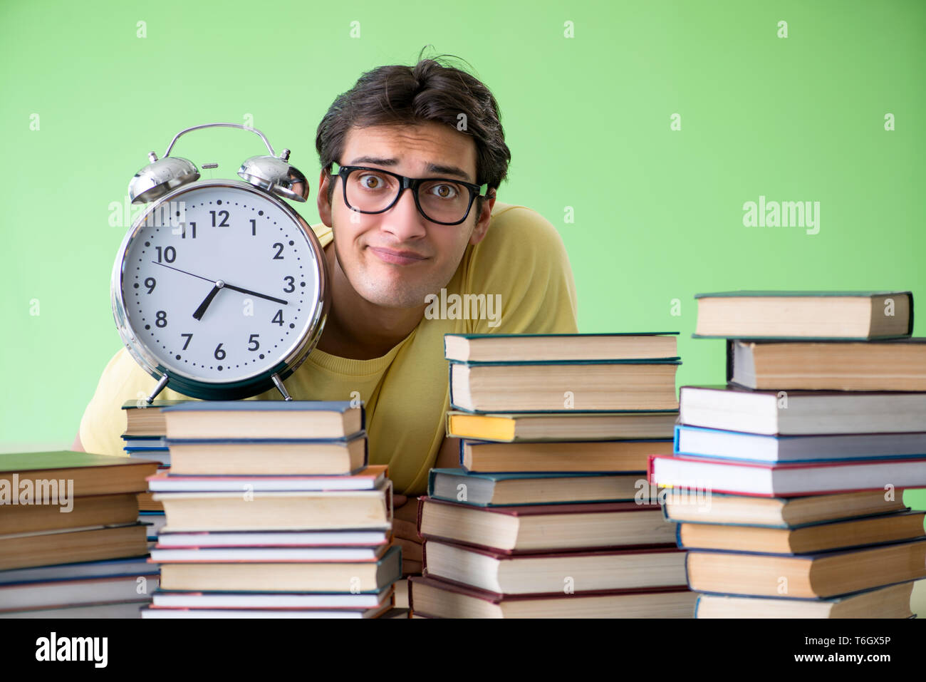 Student with too many books to read before exam Stock Photo - Alamy