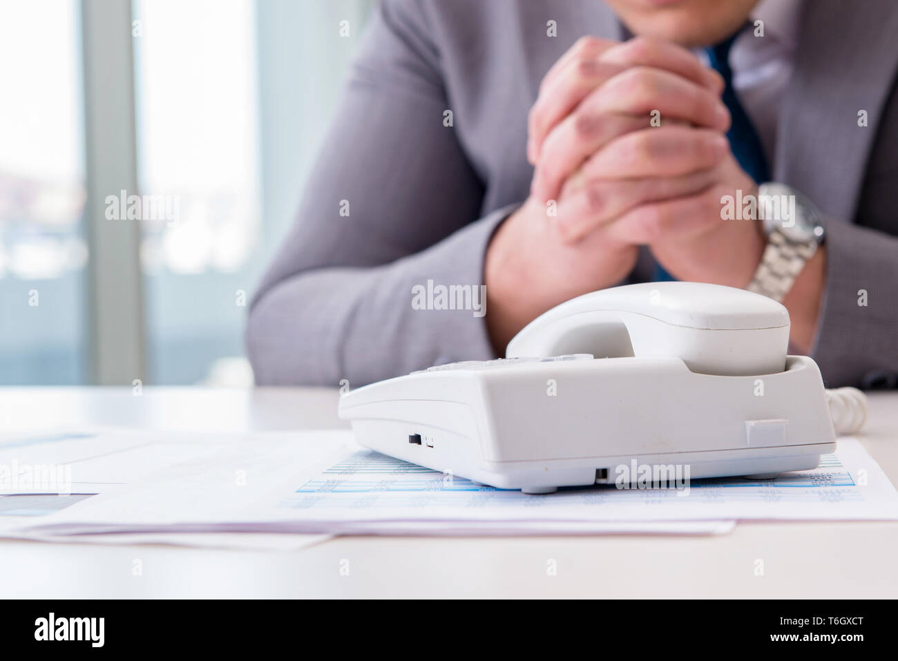 Businessman expecting important call on phone Stock Photo - Alamy