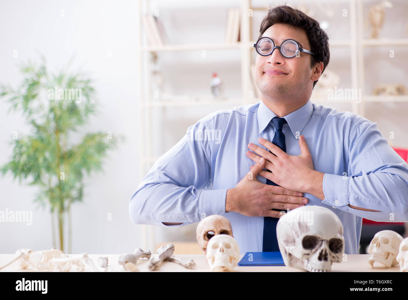 Funny crazy professor studying human skeleton Stock Photo - Alamy