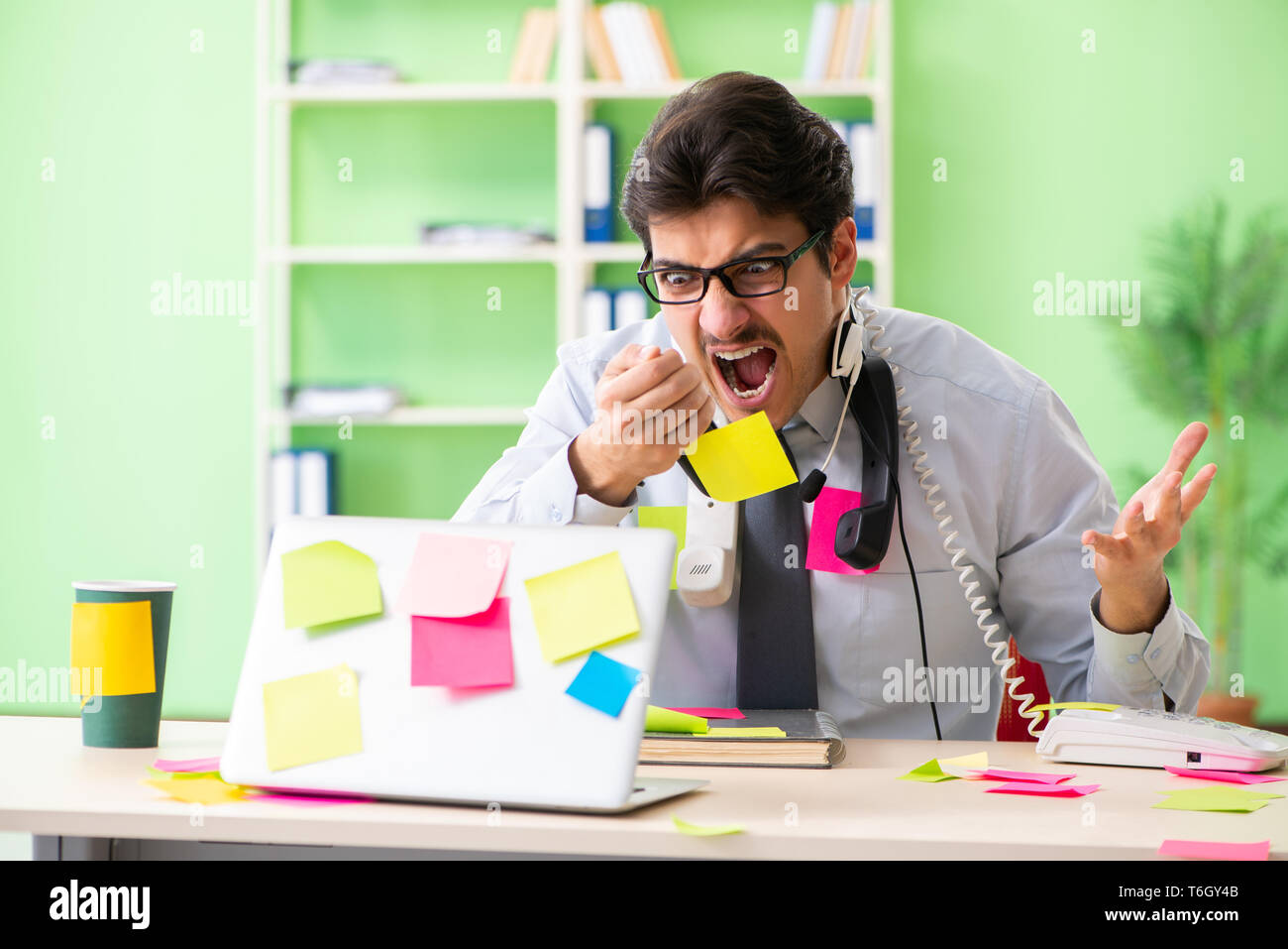 Young help desk operator working in office with many conflicting Stock ...