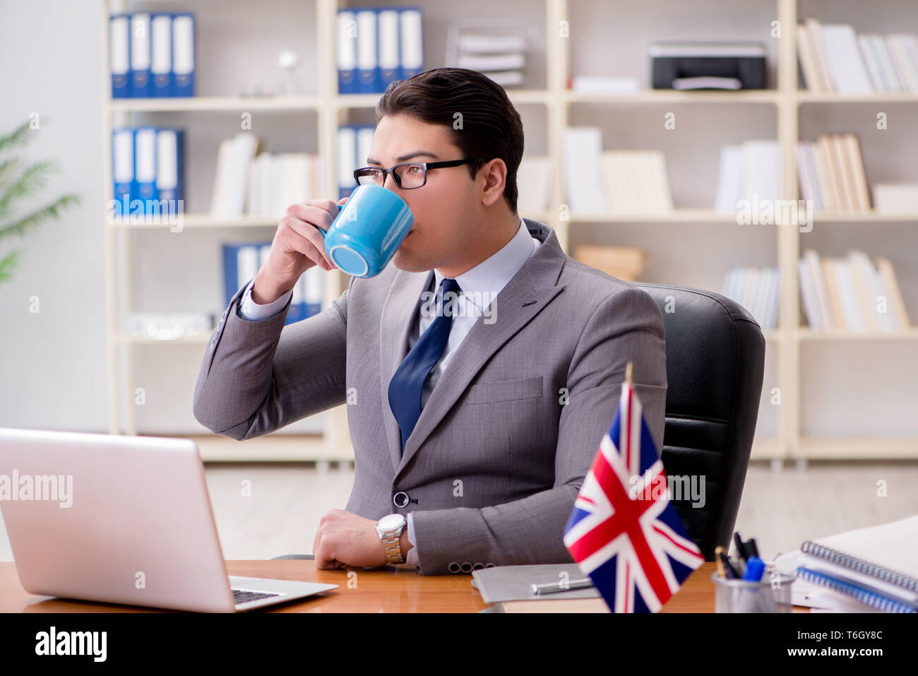 Businessman with British flag in the office Stock Photo - Alamy