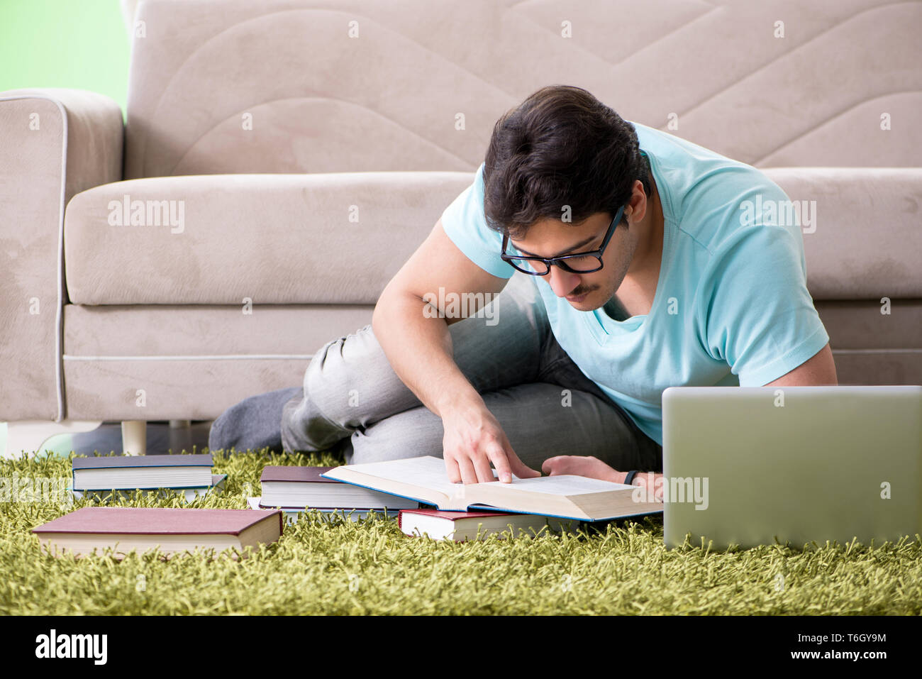 Teenager revising laptop books at home hi-res stock photography and ...