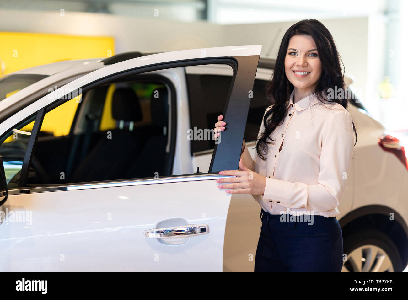 Portrait of happy customer buying new car and examines the car Stock ...