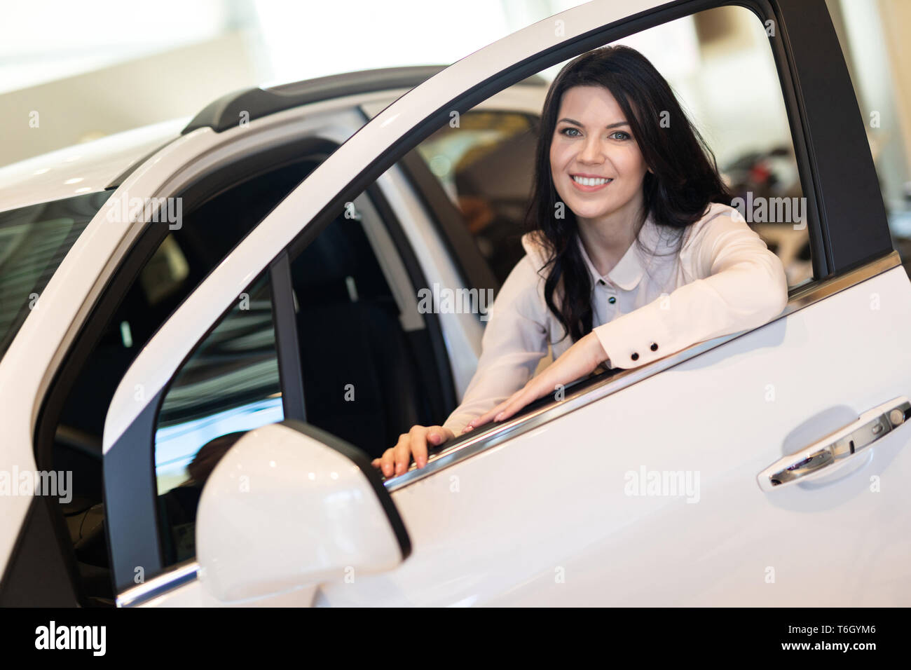 Portrait of happy customer buying new car and examines the car Stock ...