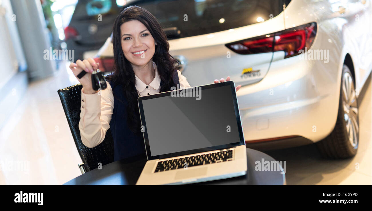 Portrait of beautiful smilling insurance agent sitting near new car ...