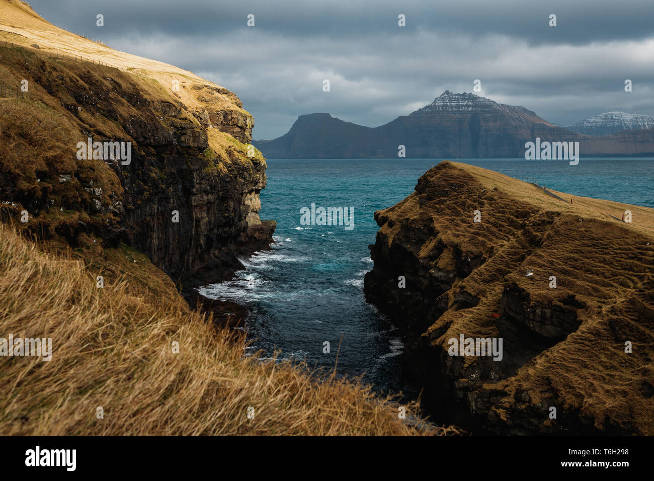 Direct view into the gorge / natural harbour of Gjógv with dramatic ...
