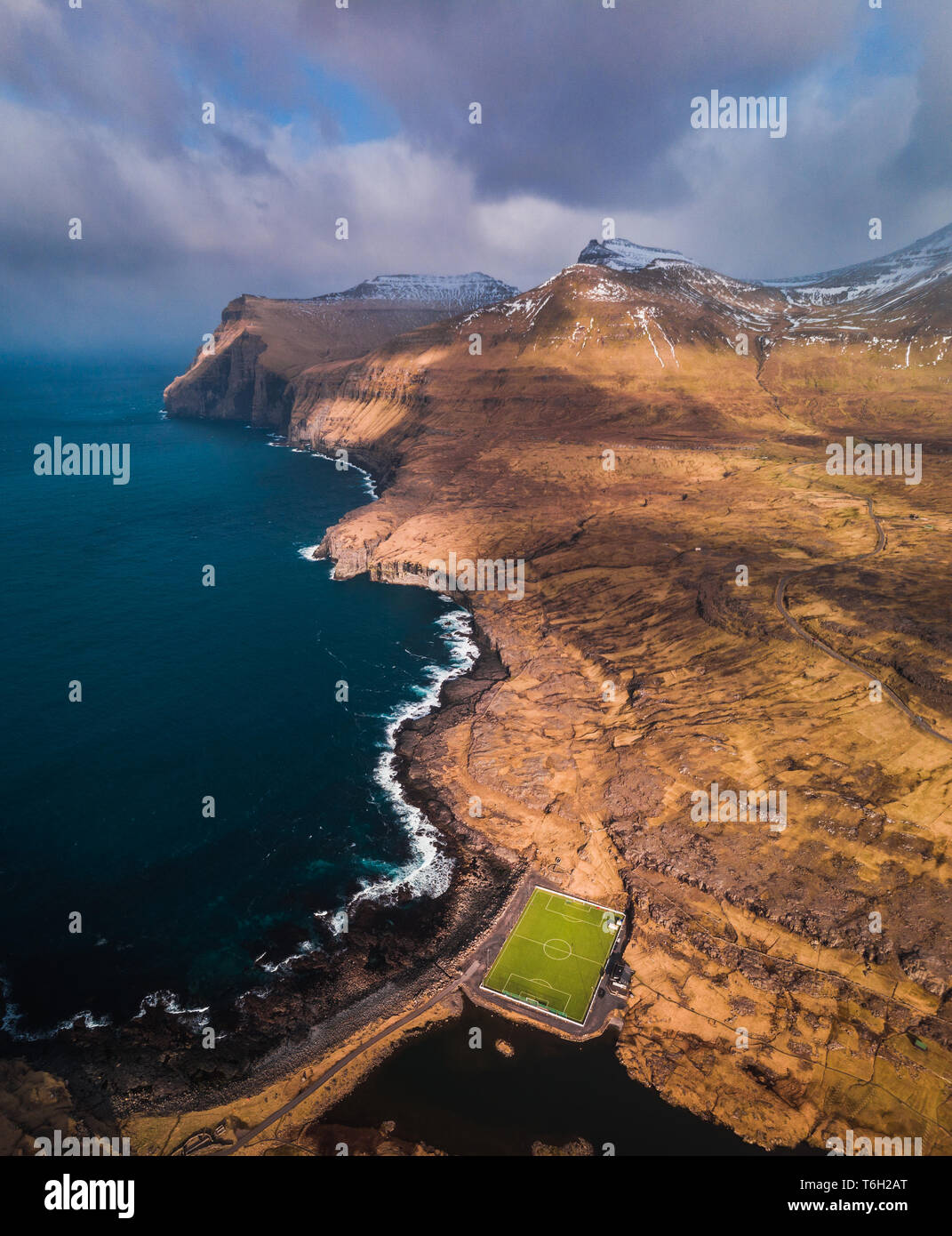 Aerial view of a football field from above with scenic mountain range ...