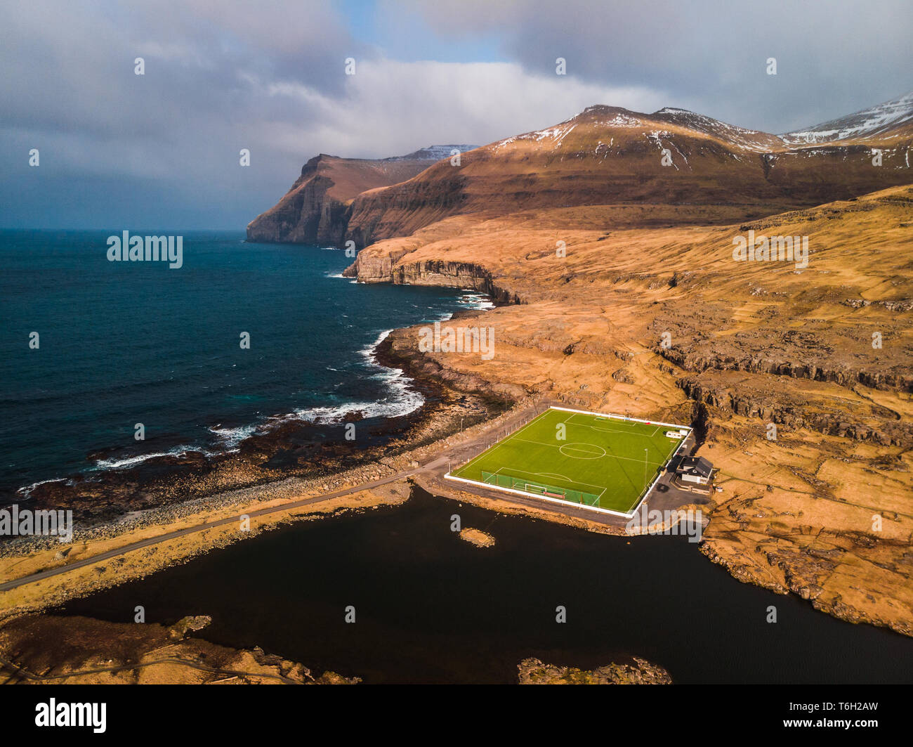 Aerial view of a football field from above with scenic mountain range ...