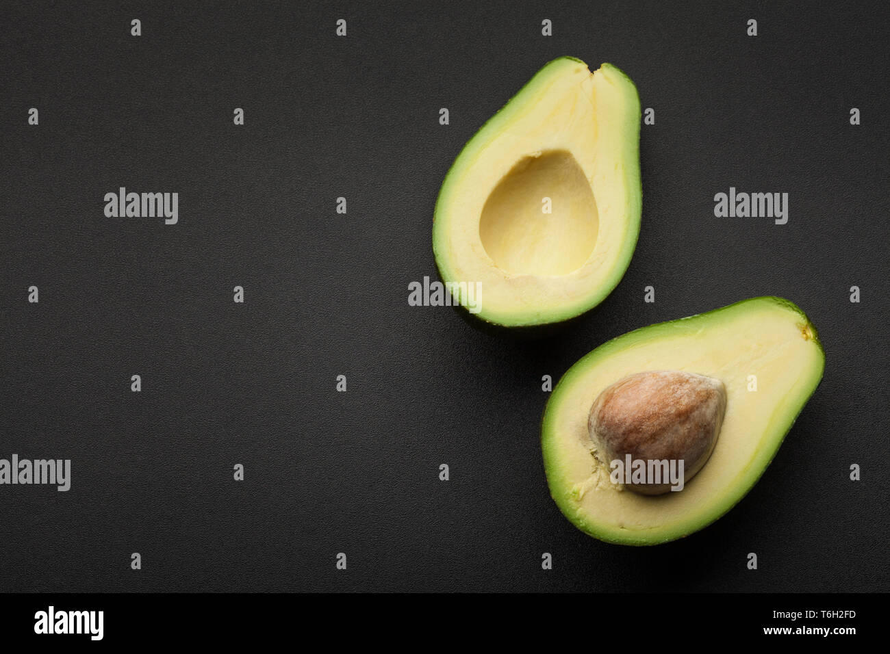 fresh green avocado isolated on dark background. top view Stock Photo ...