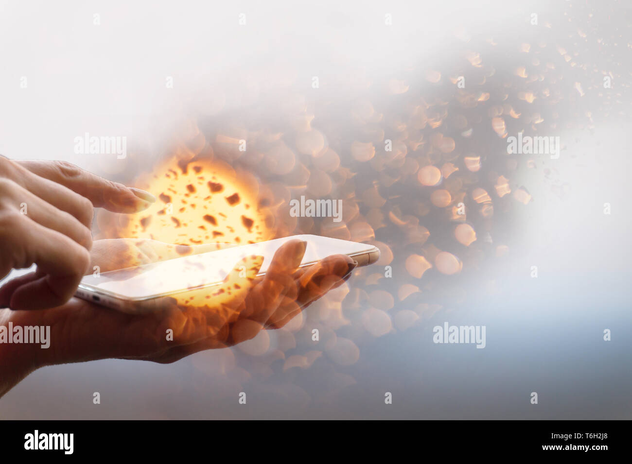 Female hand holding a smartphone with abstract glowing plasma ball and ...