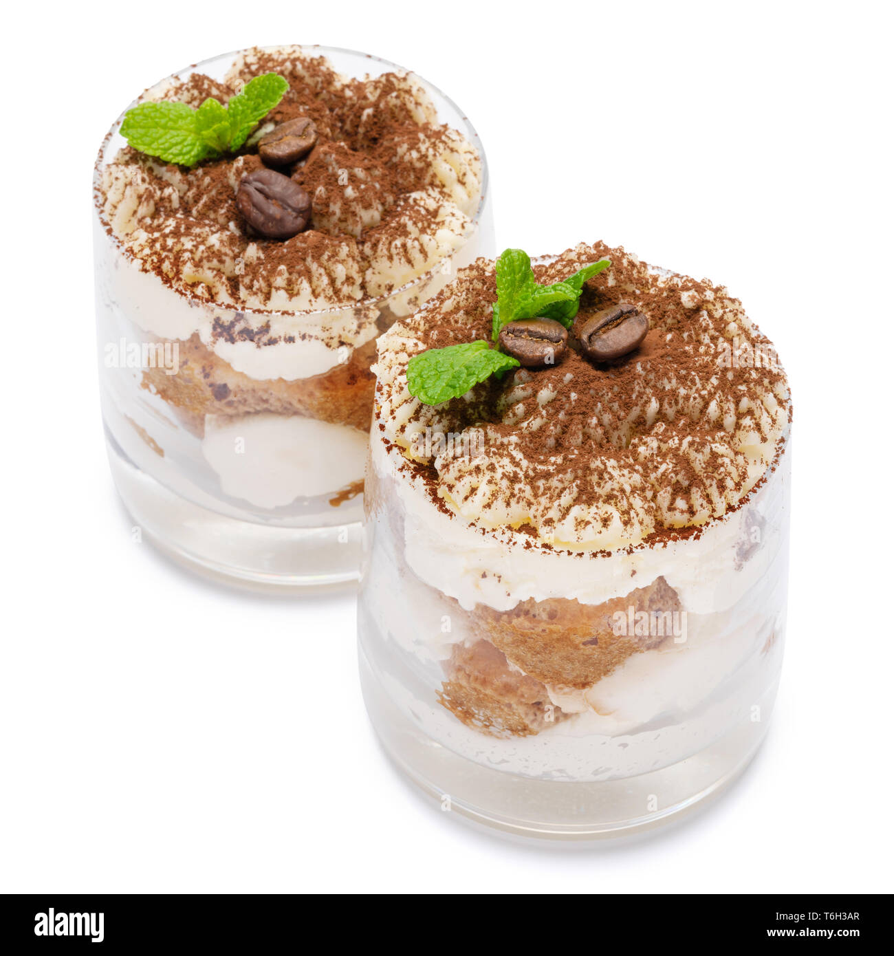 two portions Classic tiramisu dessert in a glass isolated on a white ...