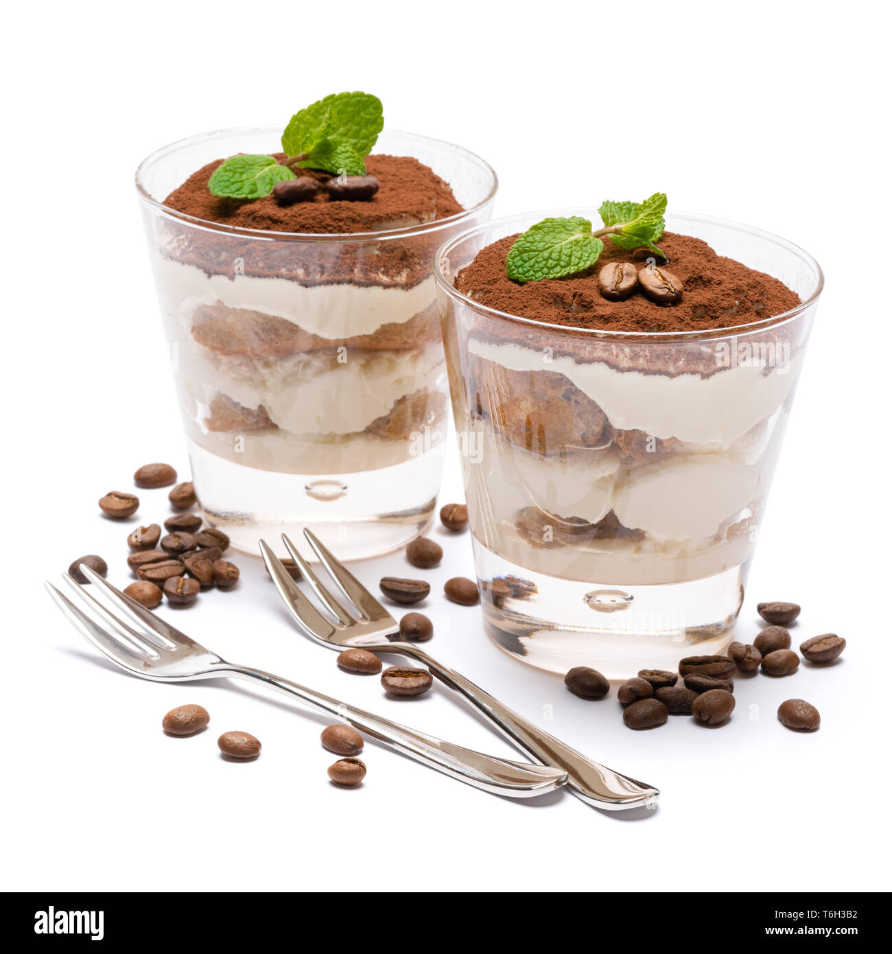 two portions Classic tiramisu dessert in a glass isolated on a white ...