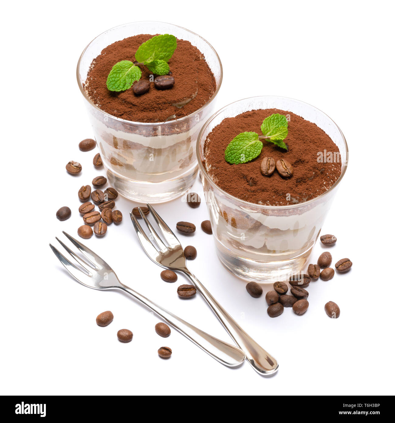 two portions Classic tiramisu dessert in a glass isolated on a white ...