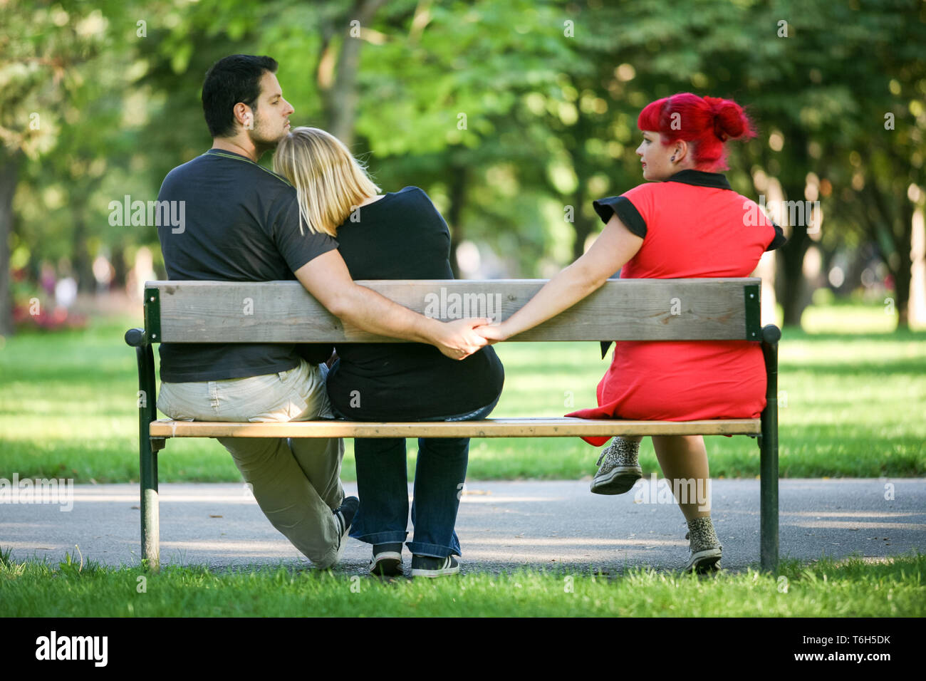 In the middle. Unfaithfulness love affair triangle Stock Photo - Alamy