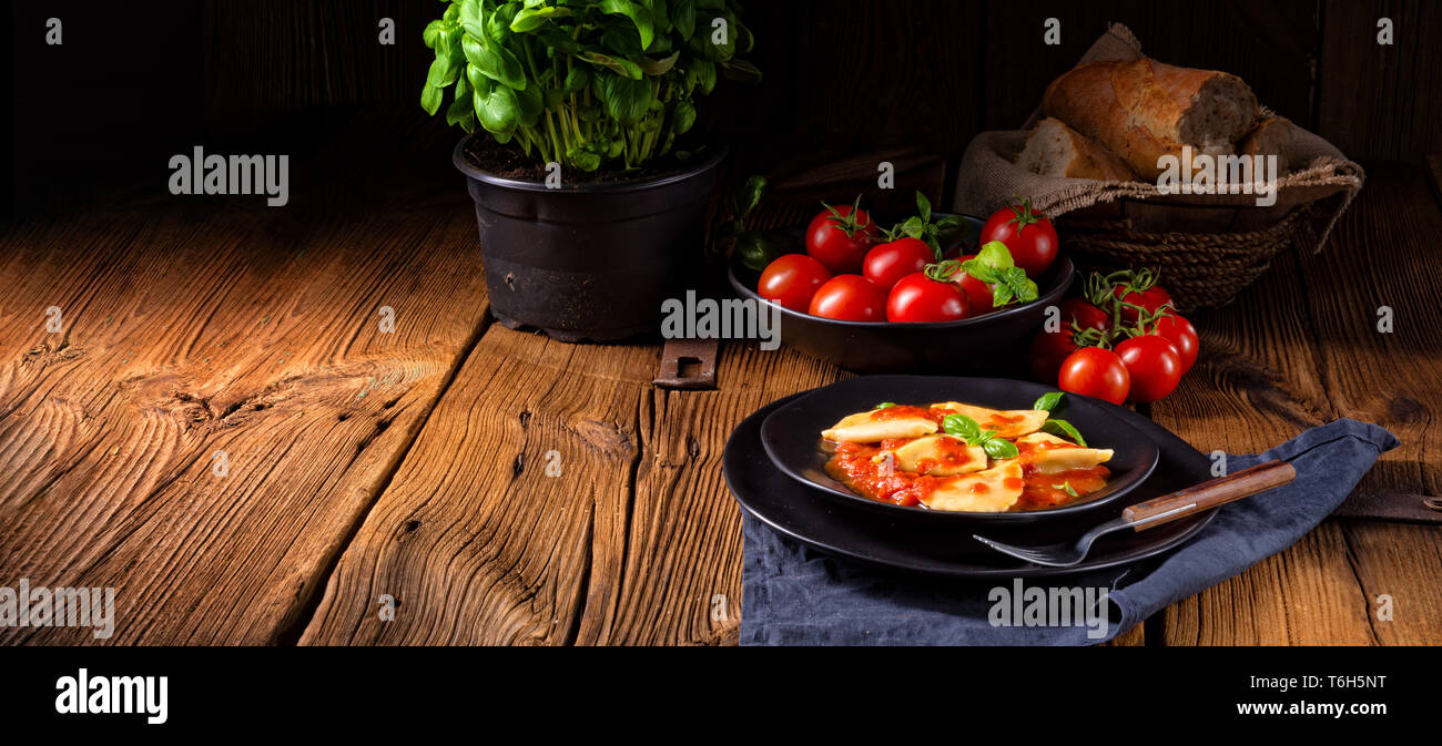 rustic Delicious Pasta - Ravioli in tomato sauce with basil Stock Photo ...