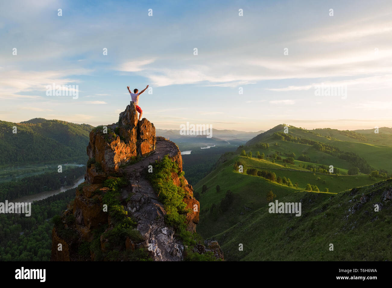 Man standing on top of cliff Stock Photo - Alamy