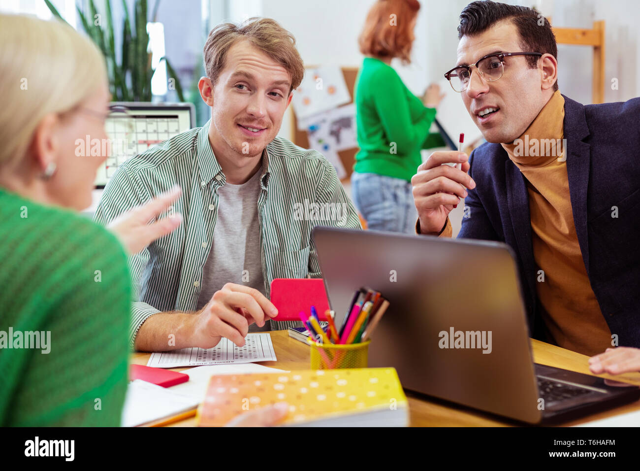 Nice smart pleasant people discussing a problem Stock Photo - Alamy
