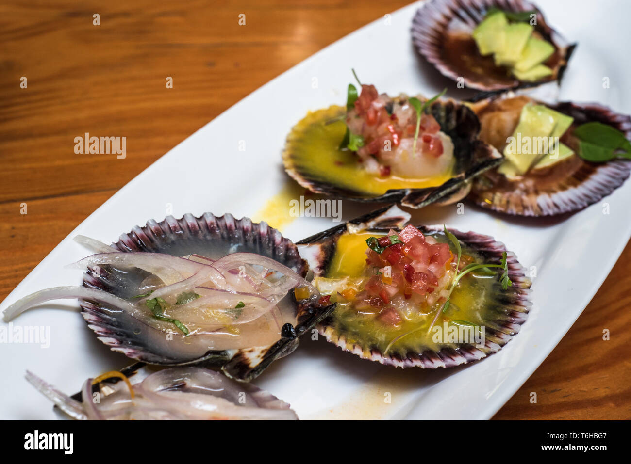fresh scallops new peruvian cuisine style Stock Photo - Alamy