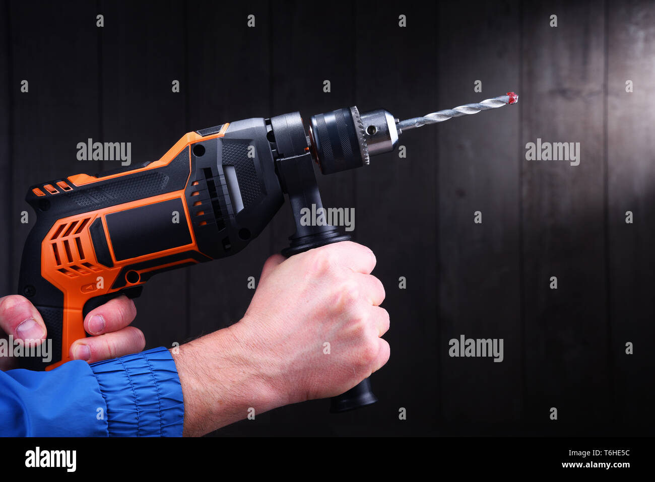 Hands hold electric drill hi-res stock photography and images - Alamy