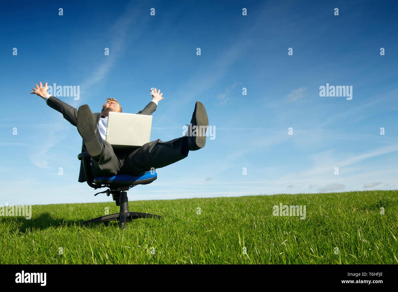 Excited businessman throwing his arms and legs to the air celebrating ...