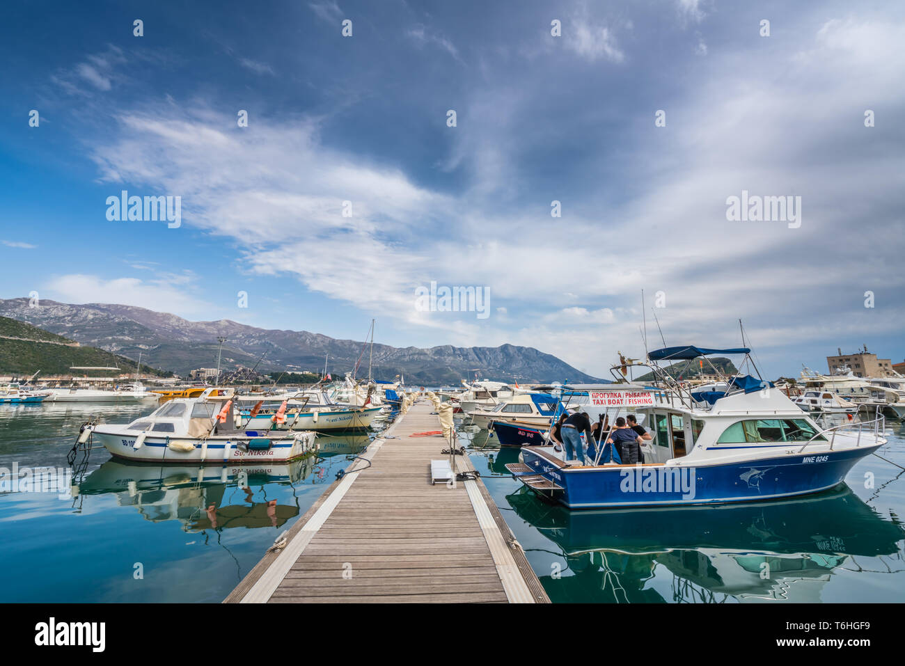 Wooden landing pier in the port in Budva Stock Photo - Alamy