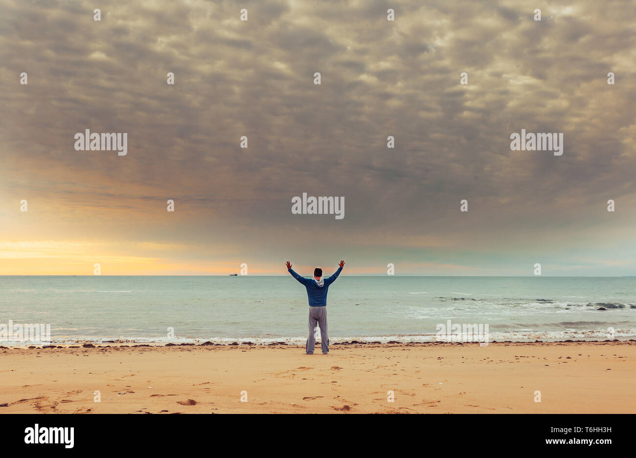 Man raised hands stand on hi-res stock photography and images - Alamy