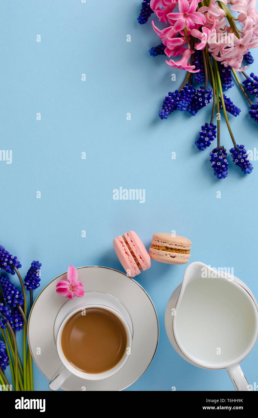 Romantic breakfast. Cup of coffee with milk, white meringues, macarons ...