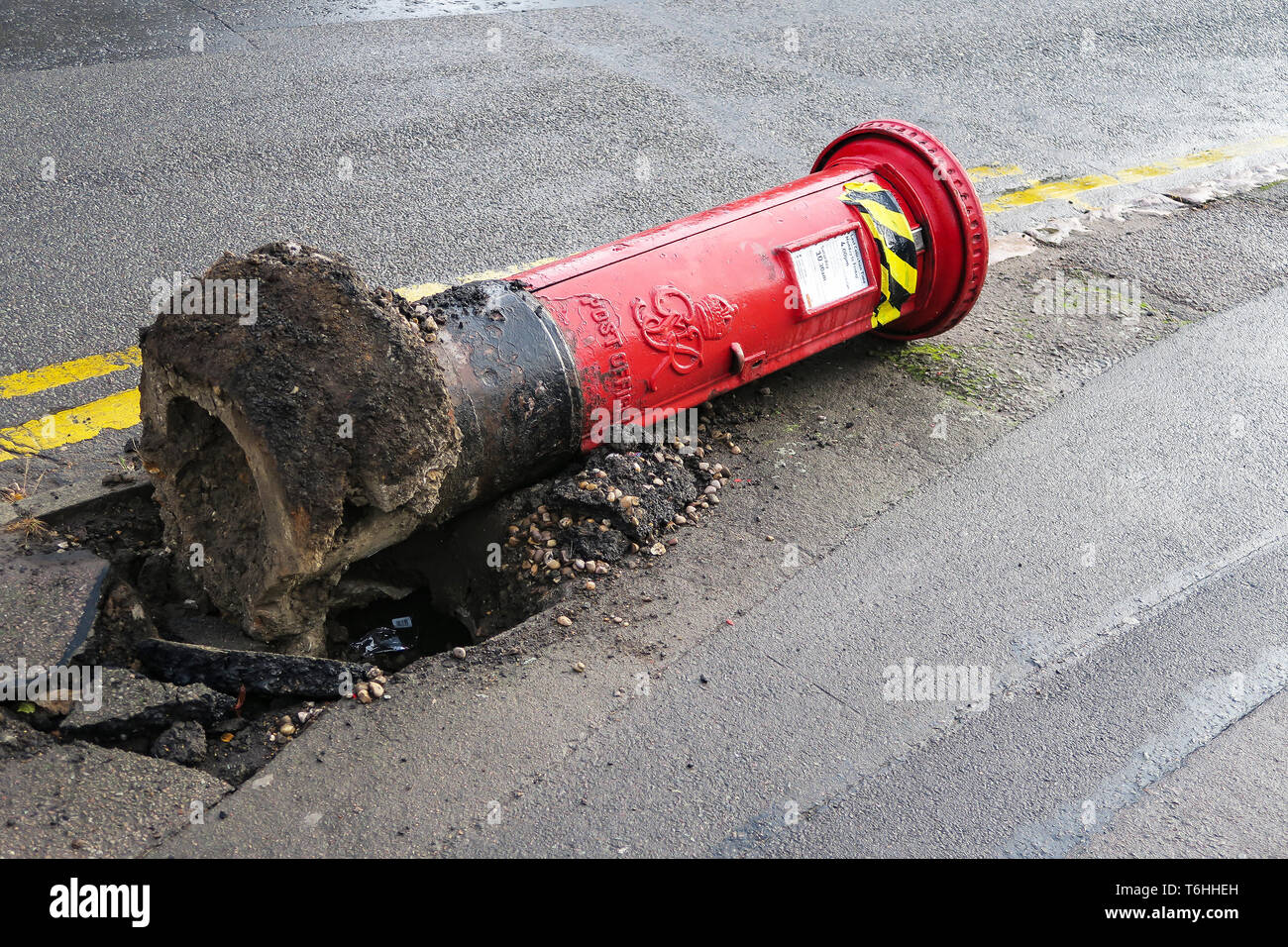 Damaged red pillar box after collision with car Stock Photo - Alamy