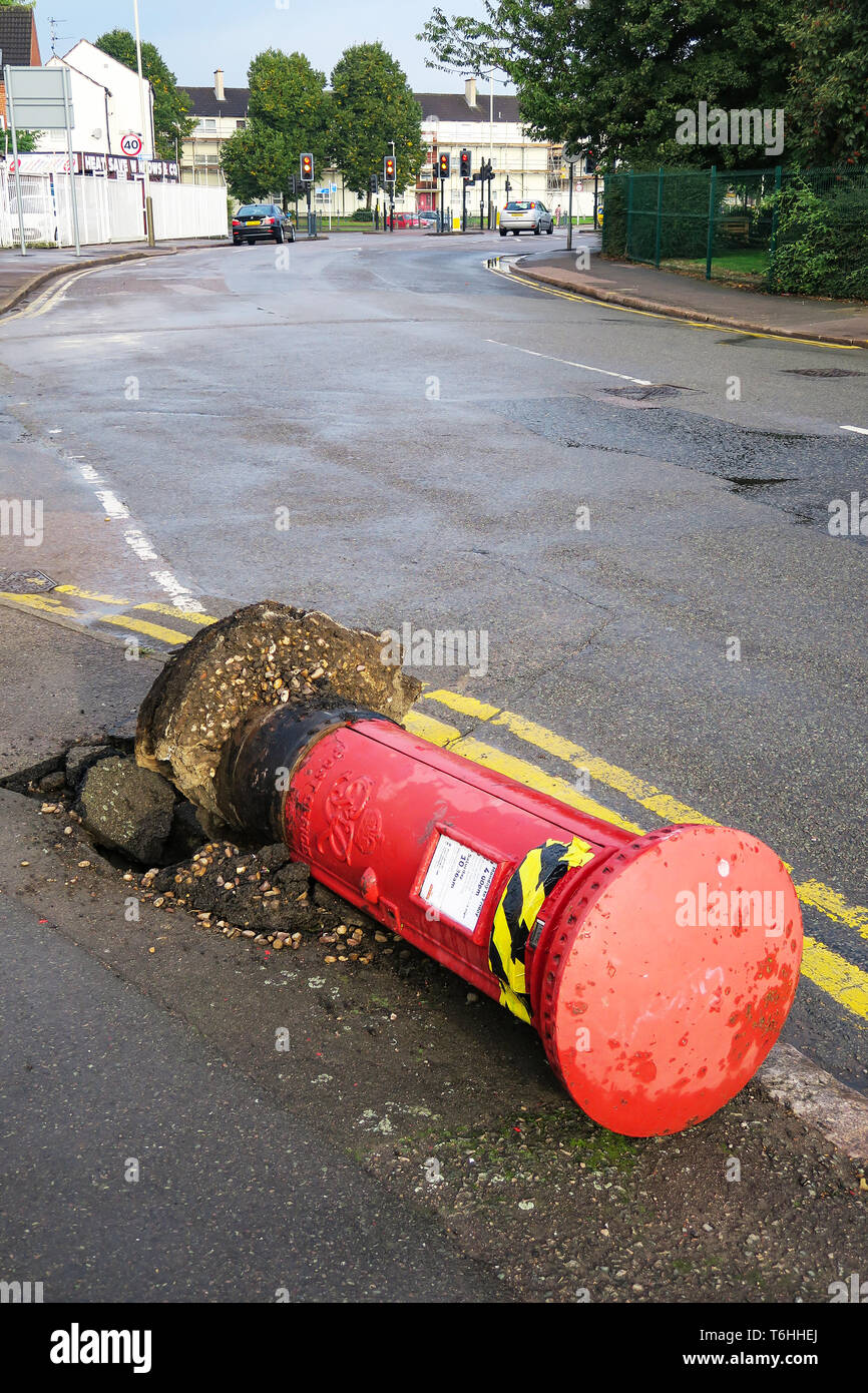 Damaged red pillar box after collision with car Stock Photo - Alamy
