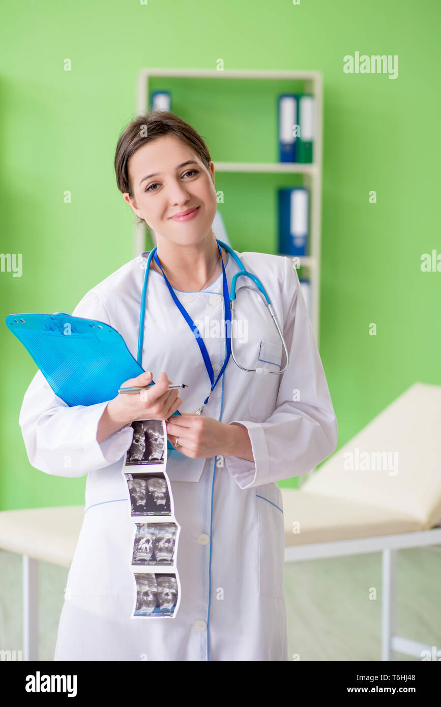 Female doctor gynecologyst writing medical record in the clinic Stock ...