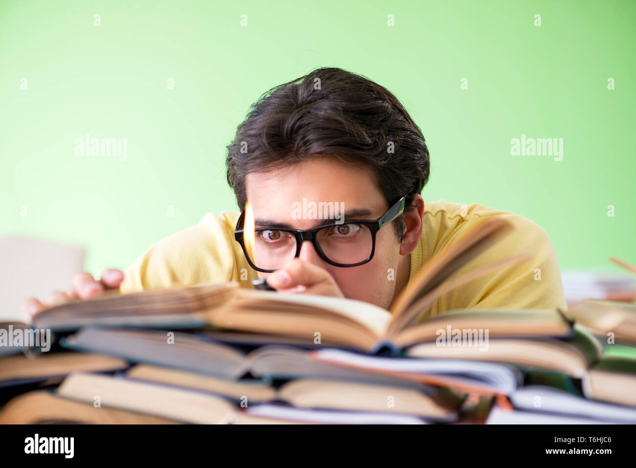 Student with too many books to read before exam Stock Photo - Alamy