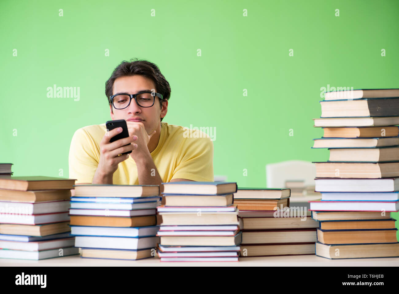 Student with too many books to read before exam Stock Photo - Alamy