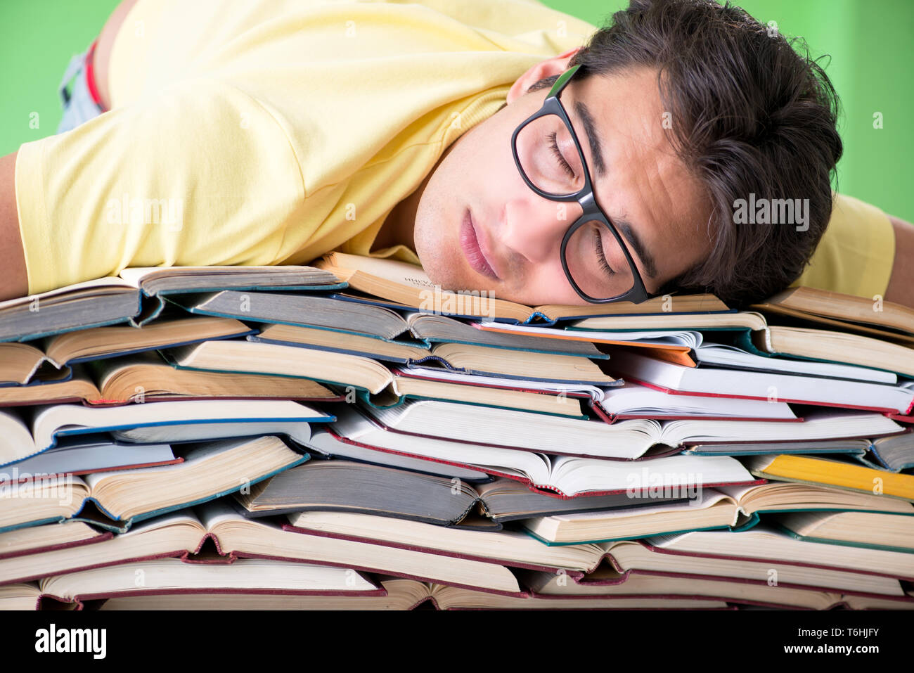 Student with too many books to read before exam Stock Photo - Alamy