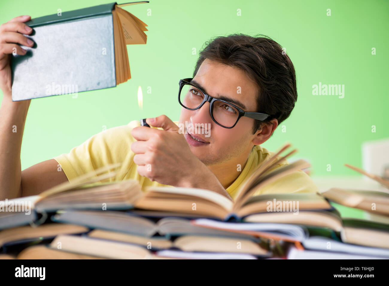 Student with too many books to read before exam Stock Photo - Alamy
