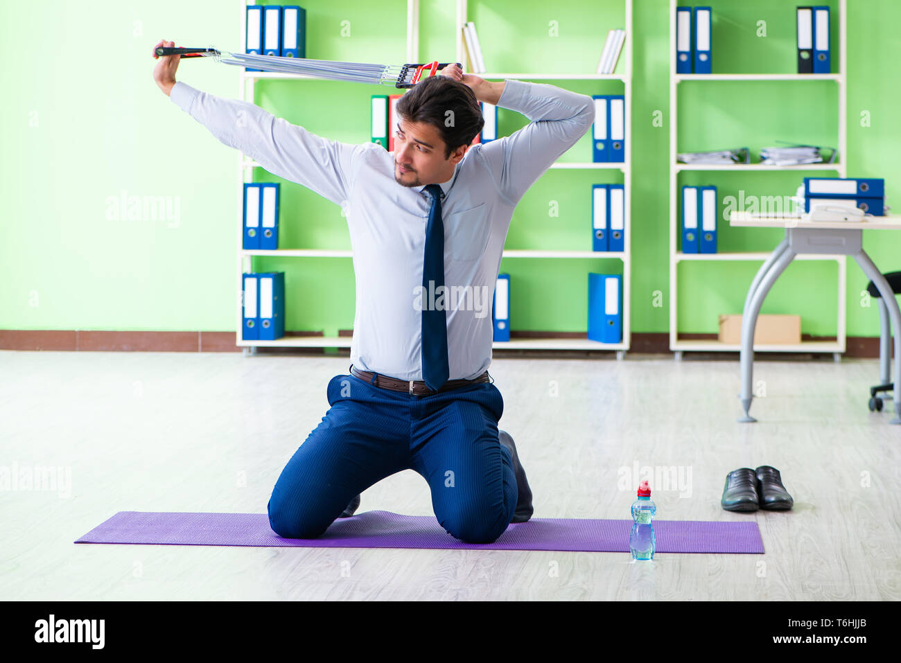 Employee doing exercises during break at work Stock Photo - Alamy