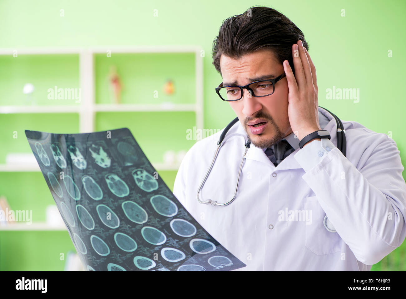 Doctor radiologist looking at x-ray scan in hospital Stock Photo - Alamy