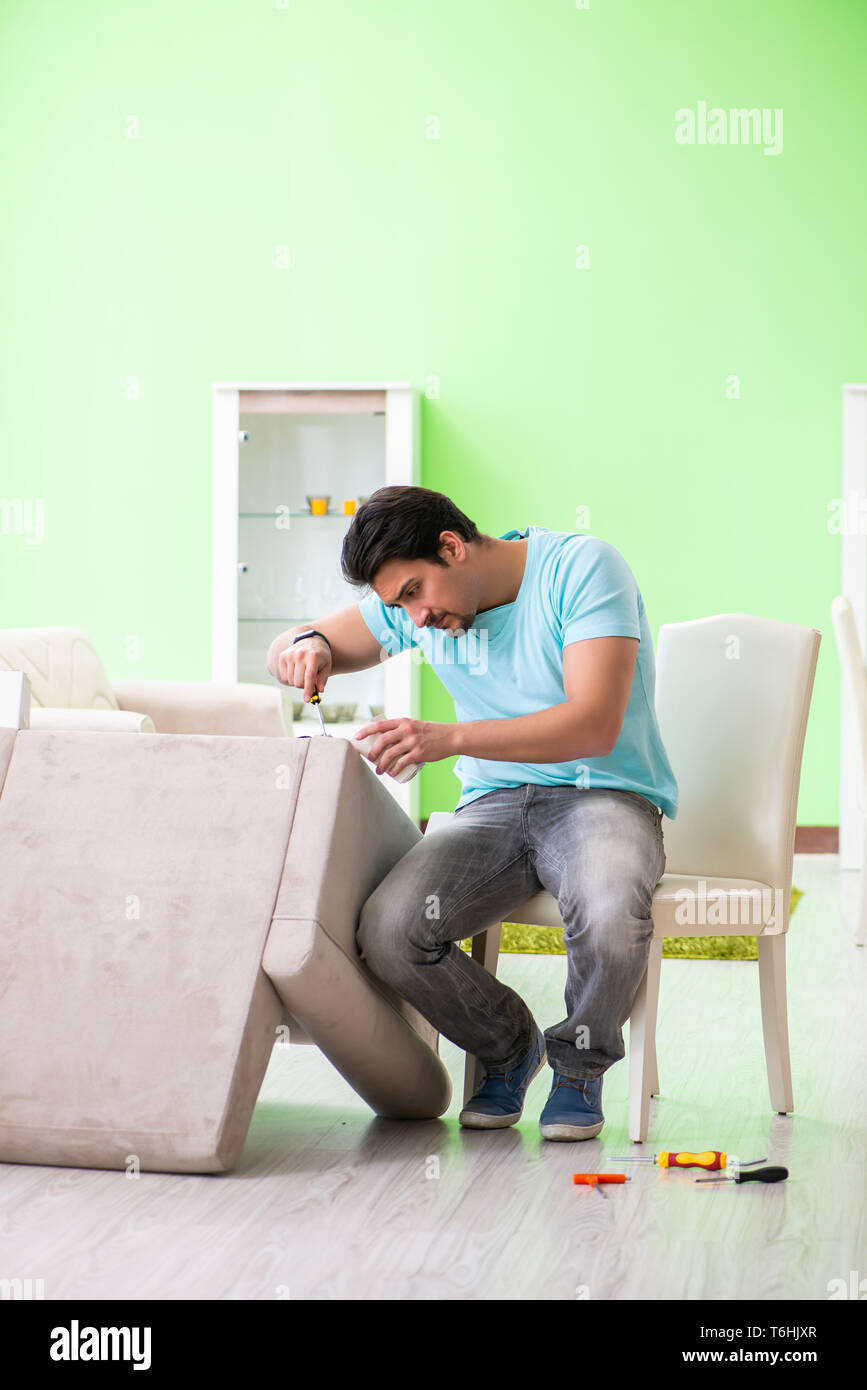 Man repairing furniture at home Stock Photo - Alamy