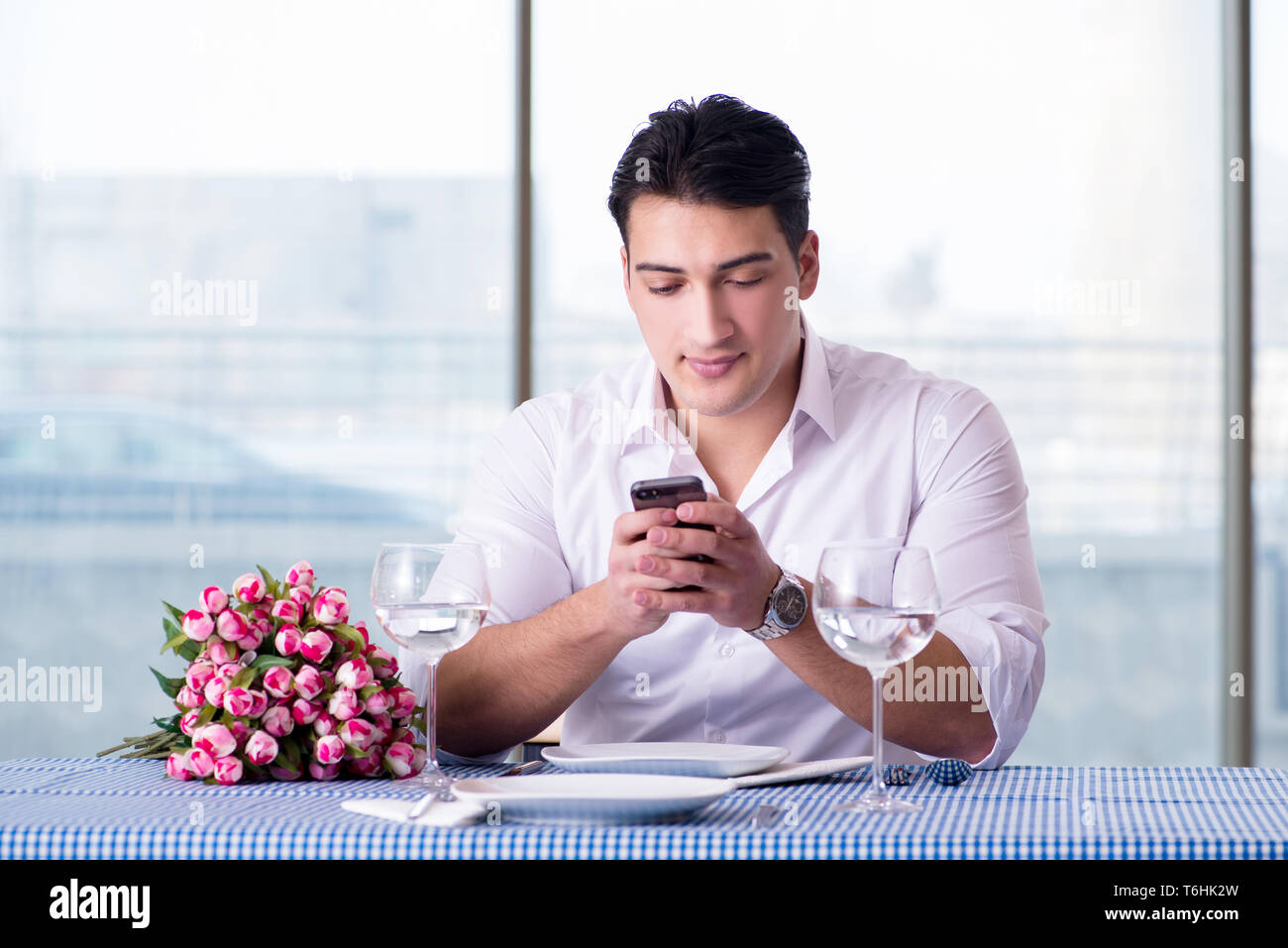 Handsome man alone in restaraunt on date Stock Photo - Alamy