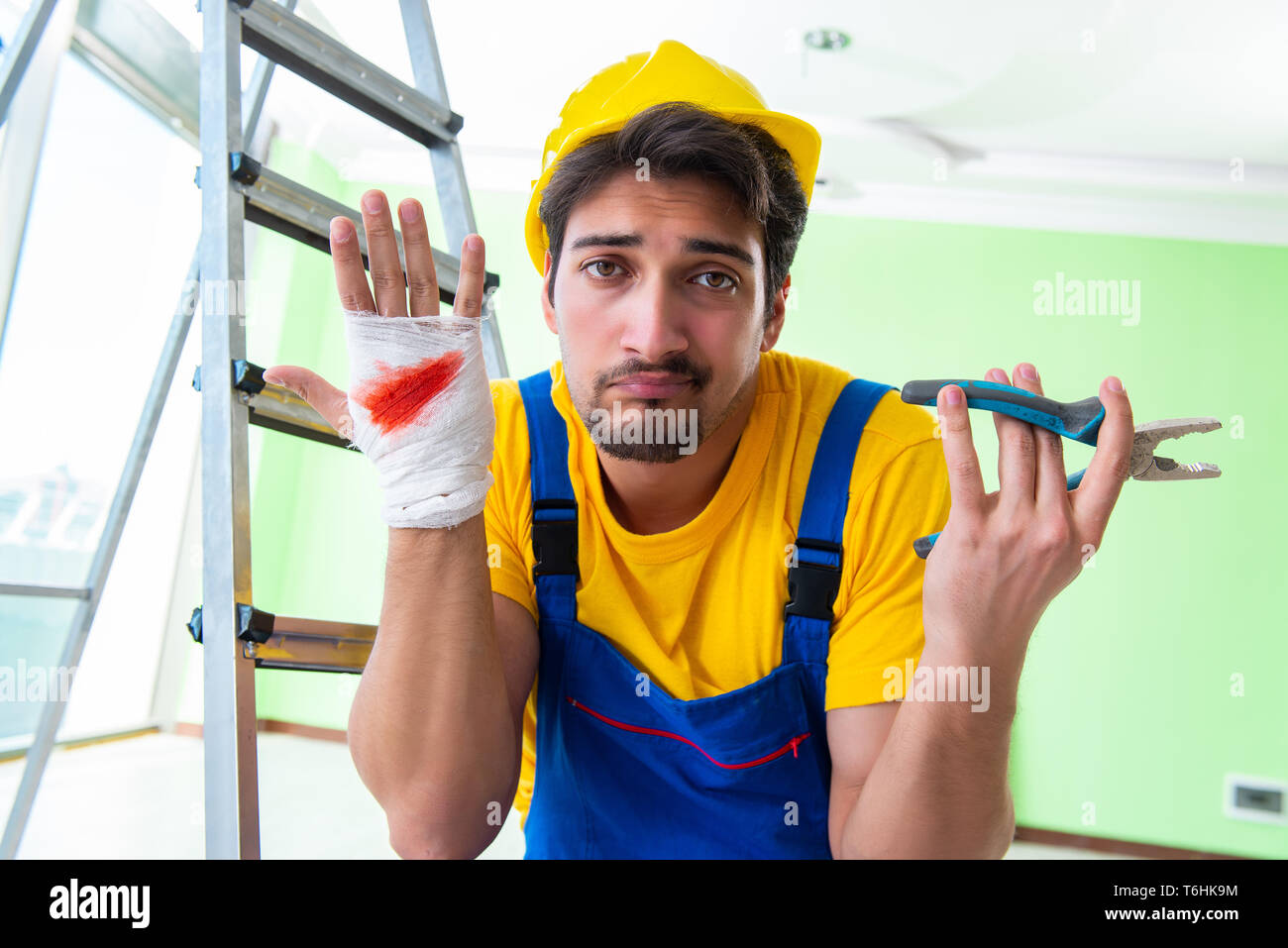 Injured worker at the work site Stock Photo - Alamy