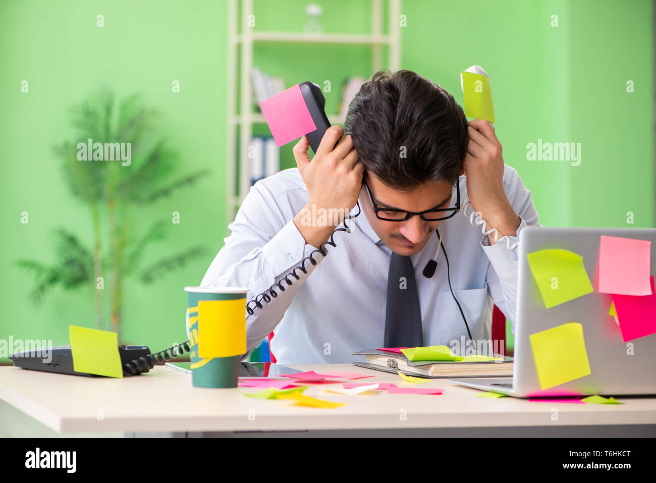 Young help desk operator working in office with many conflicting Stock ...