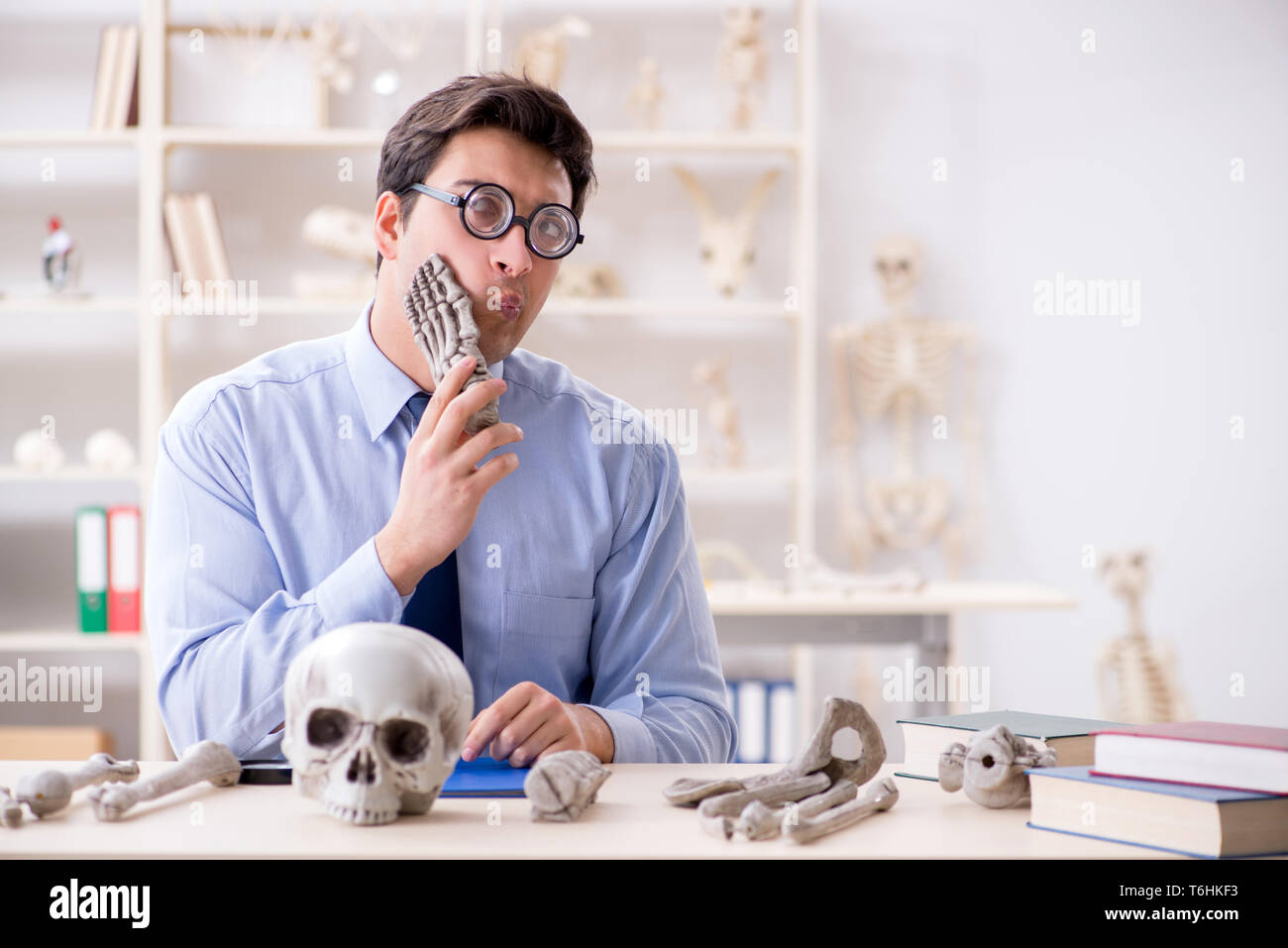Funny crazy professor studying human skeleton Stock Photo - Alamy