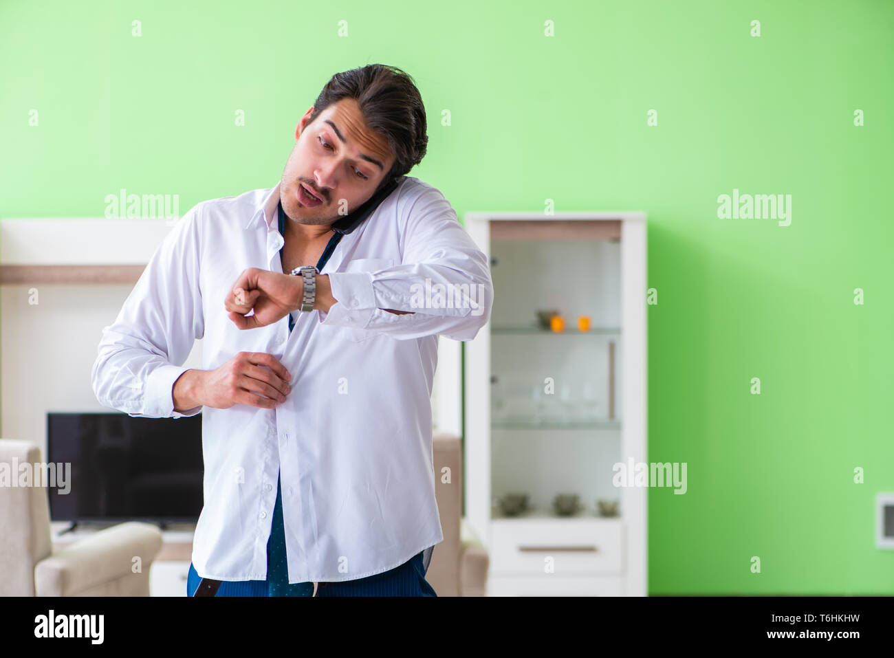 Man dressing up and late for work Stock Photo - Alamy