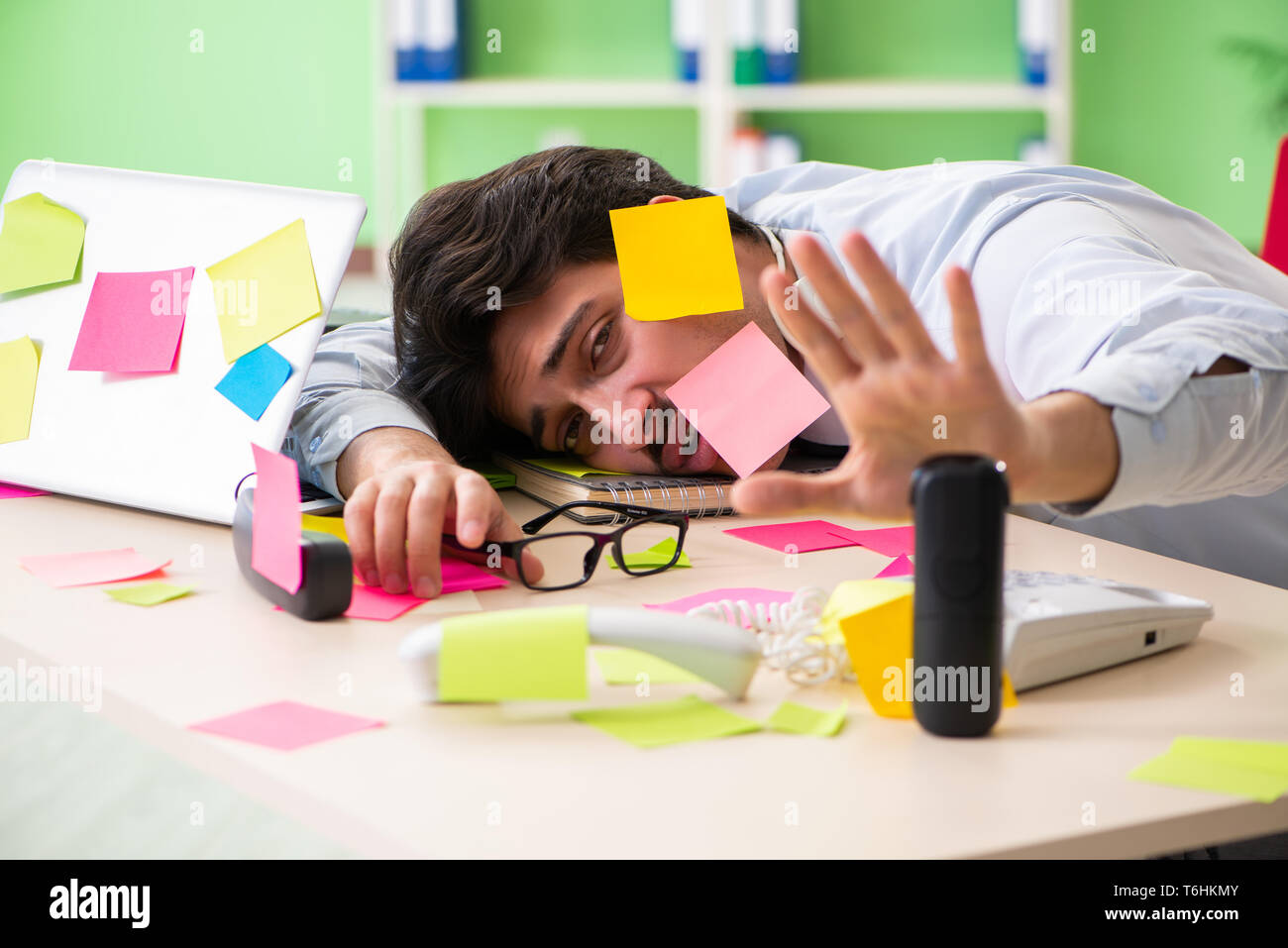 Young help desk operator working in office with many conflicting Stock ...