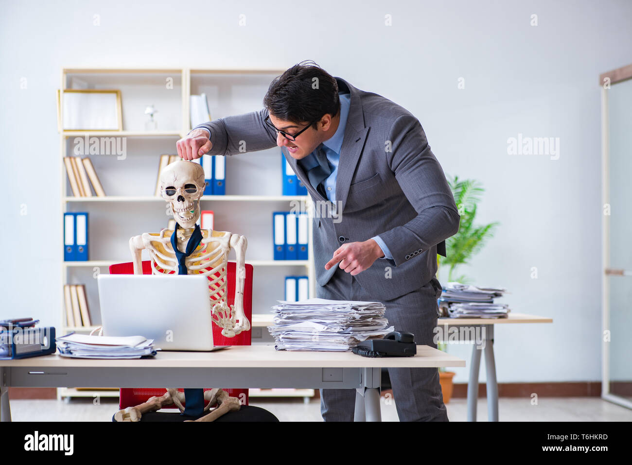 Angry boss yelling at his skeleton employee Stock Photo - Alamy